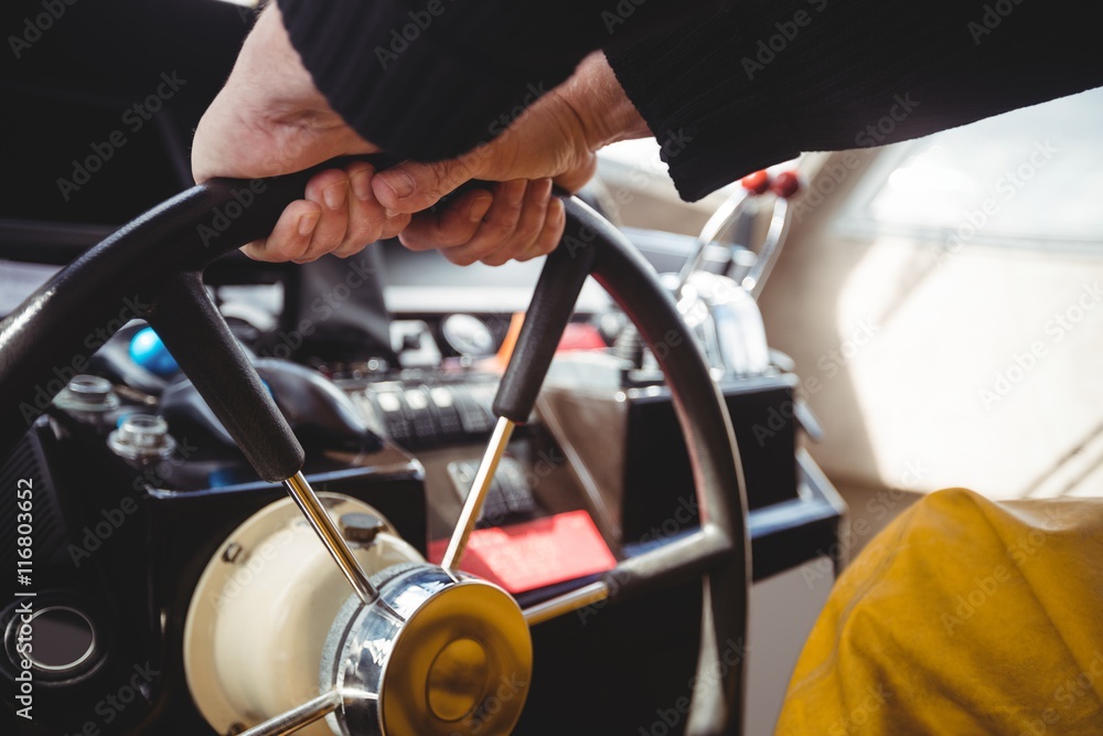 Fisherman driving fishing boat Stock Photo | Adobe Stock