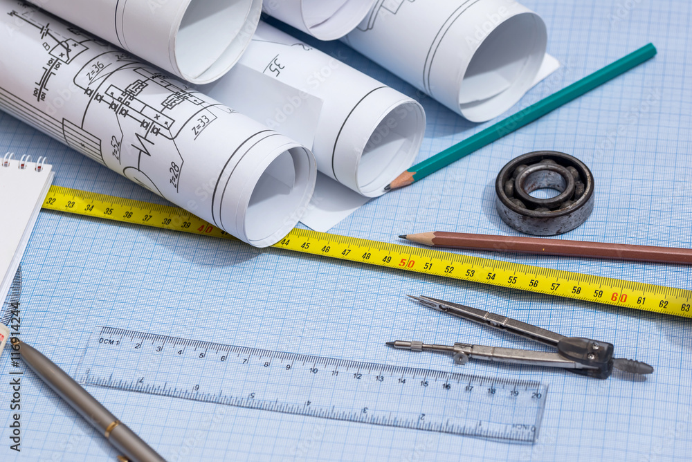 rolls of engineering drawings with tools on graph background Stock ...