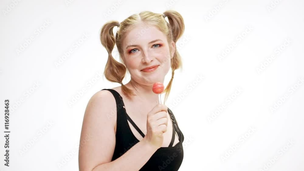 Young beautiful girl dancing, smiling, holding chupa chups over white ...