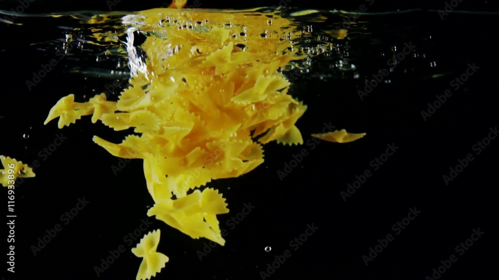 Traditional Italian cuisine slow motion farfalle pasta falling into ...