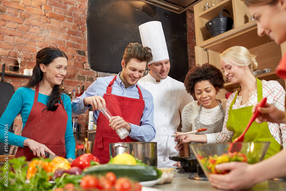 happy friends and chef cook cooking in kitchen Stock Photo | Adobe Stock