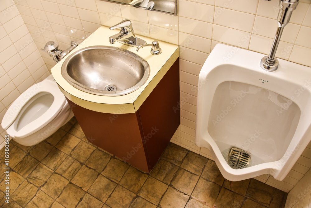 Toilet sink and urinal next to each other Stock Photo | Adobe Stock