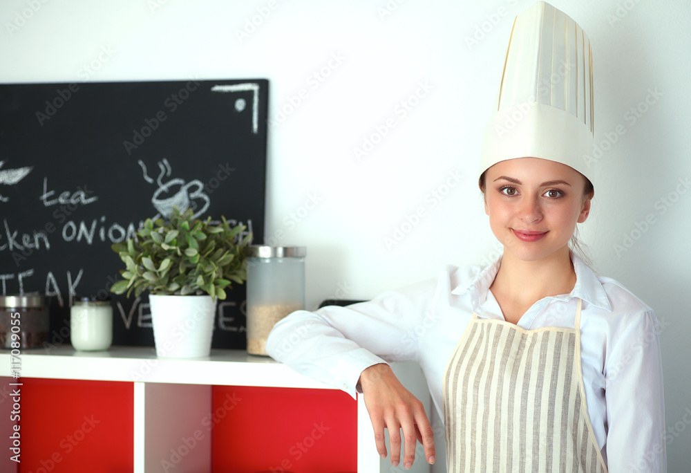 Chef woman portrait with uniform in the kitchen Photos | Adobe Stock