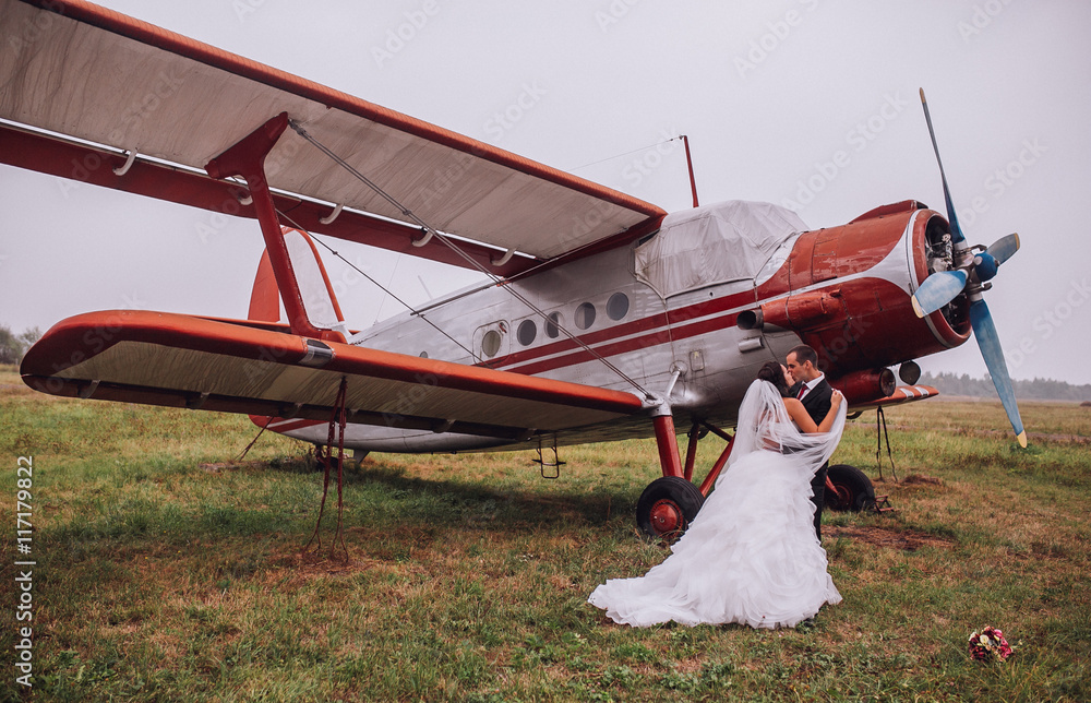 wedding couple at the airport with planes. groom and bride fly to ...