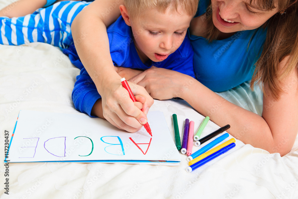 hands of mother and child writing letters Stock Photo | Adobe Stock