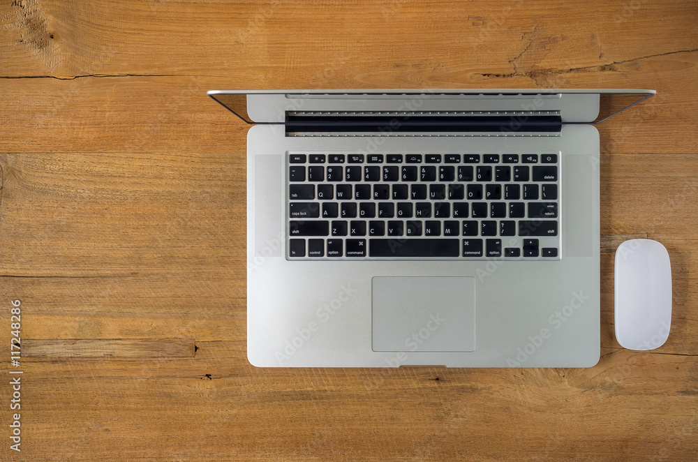 Laptop and mouse on desk. Stock-Foto | Adobe Stock