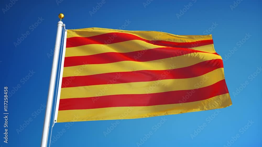 Catalunya flag waving in slow motion against clean blue sky, seamlessly ...