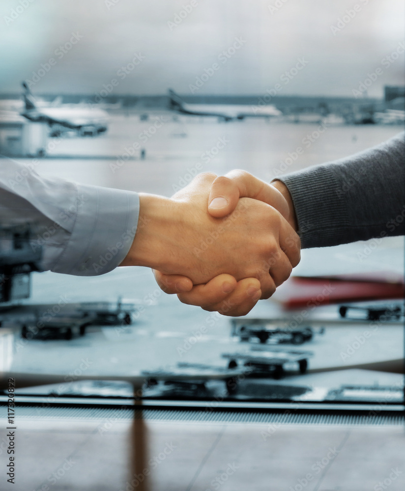 Business handshake on International Airport Terminal background Stock ...