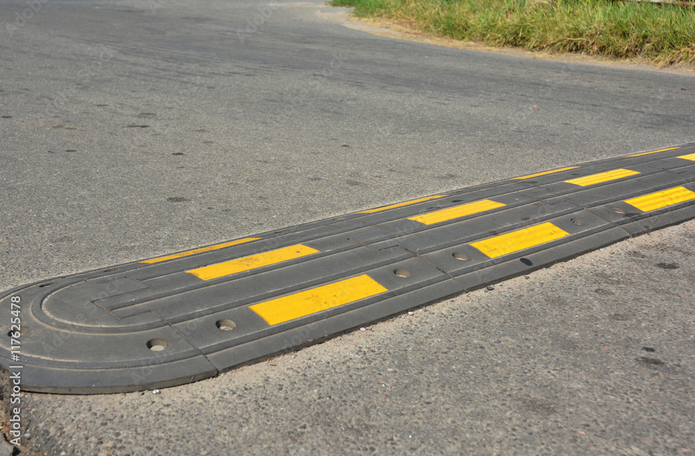 Traffic safety speed bump on an asphalt road. Speed bumps (or speed ...