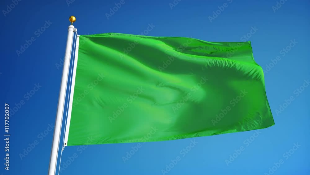 Light green flag waving in slow motion against blue sky, seamlessly ...