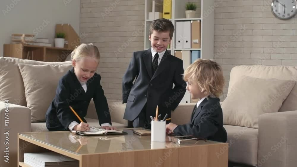 Three little kids working in business center. Girl and boy employees in ...