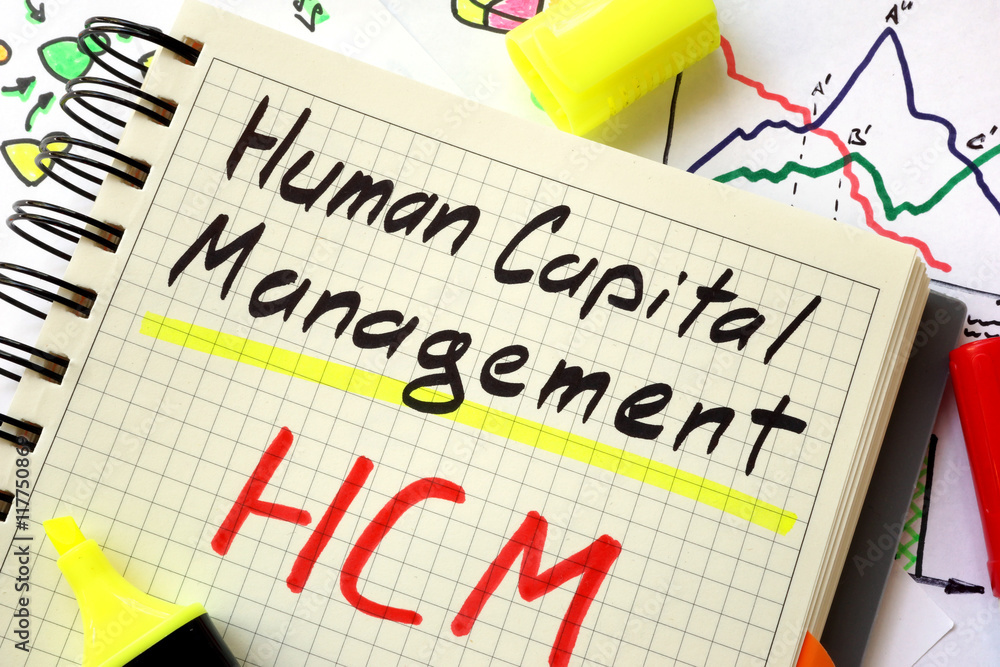Sign human capital management HCM on a page of notebook. Stock Photo ...