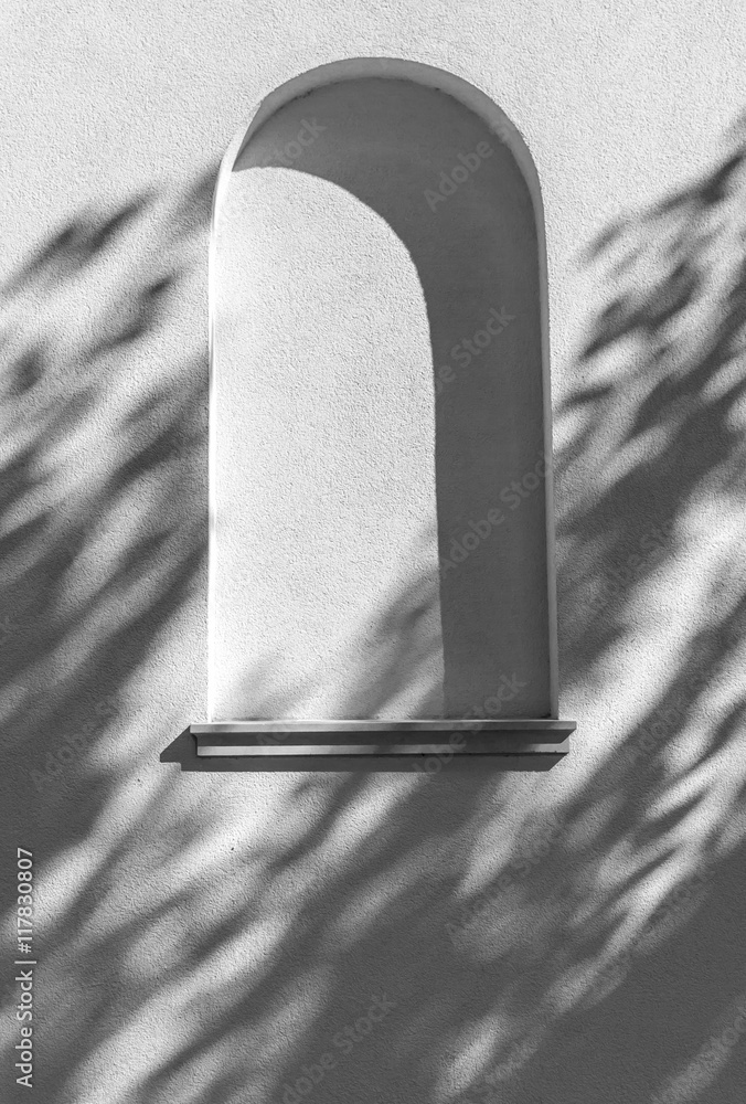 Isolated stucco window frame with tree branch shadows. Abstract sealed ...