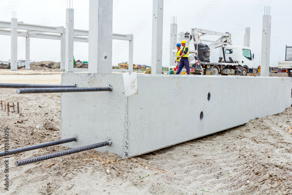 Photo & Art Print Giant reinforced concrete column is placed on sandy ...