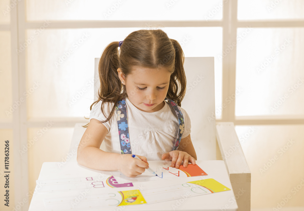 Little child writing letter A. Learning to write. Little girl writing ...