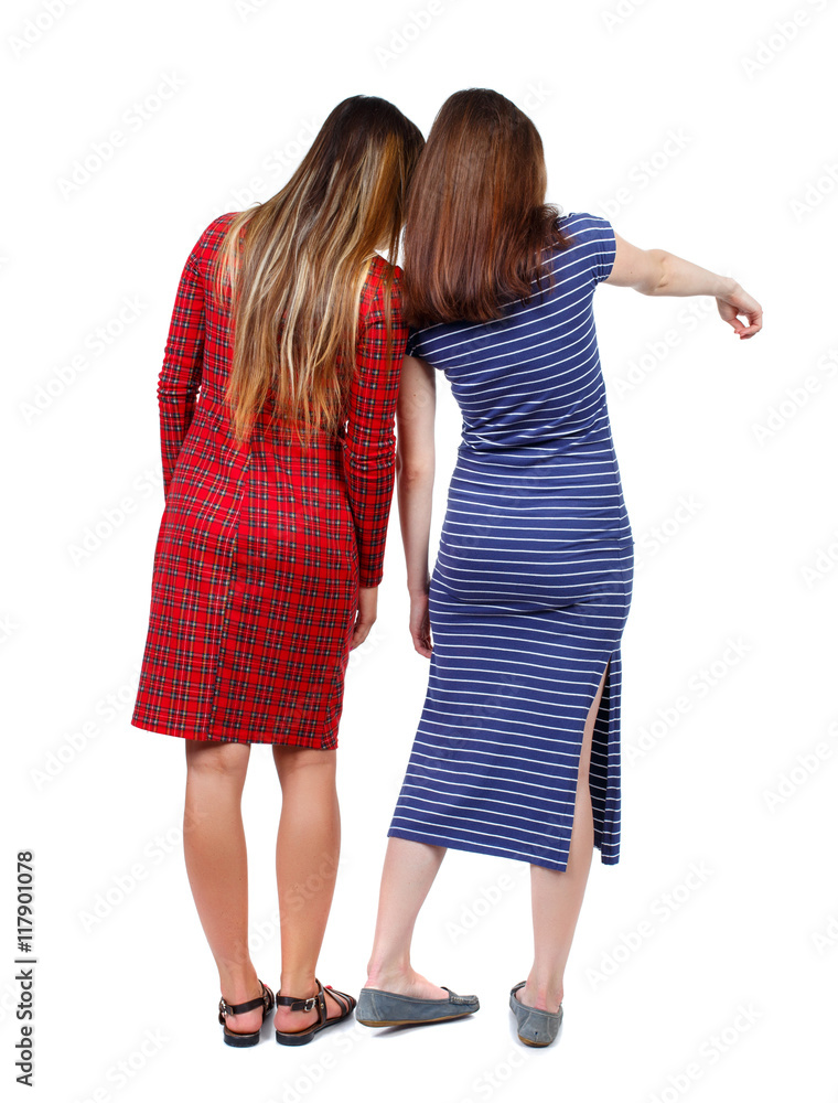 Back view of two pointing young girl. Rear view people collection ...