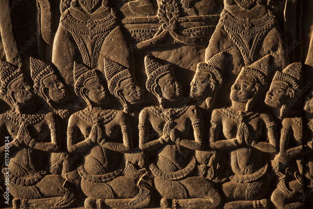 Bas-reliefs in Angkor Wat Temple, Cambodia. Grazing light at sunset ...
