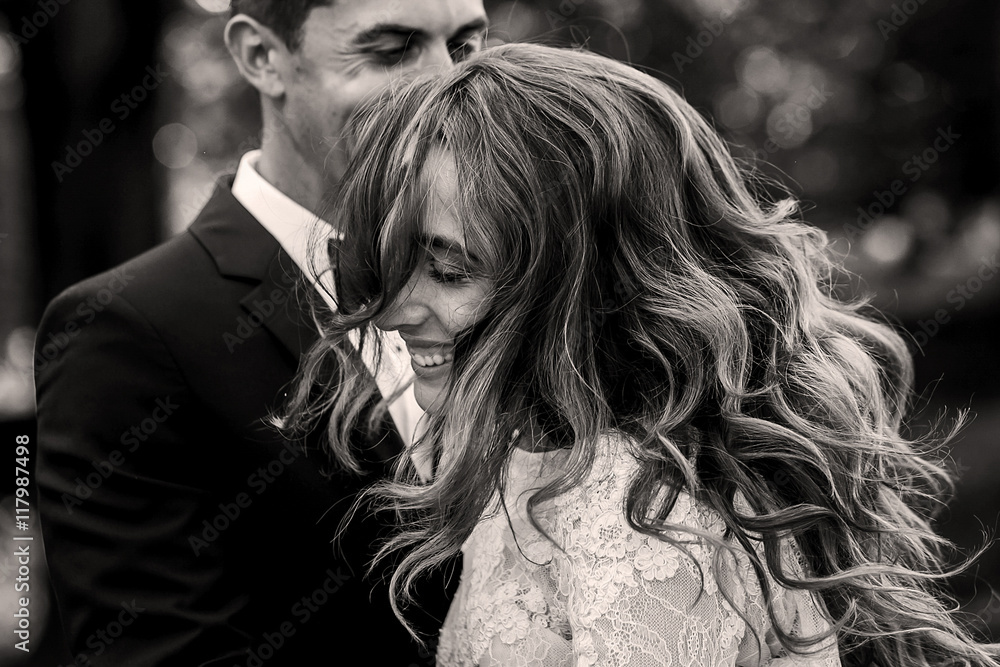 Black and white picture of bride smiling through the waves of he Stock ...