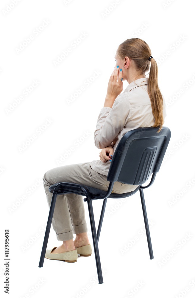 back view of young beautiful woman sitting on chair. girl watching ...