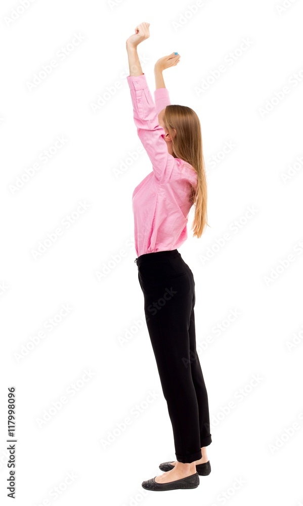 Back view of joyful woman celebrating victory hands up. Rear view ...