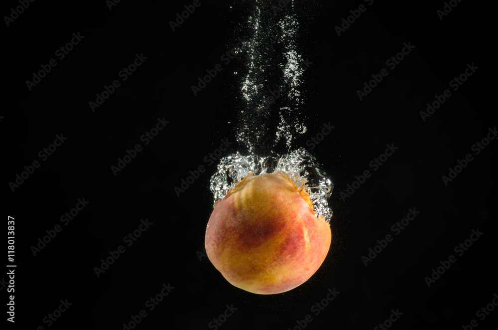 The peach in water splash with bubbles on a black background. Stock ...