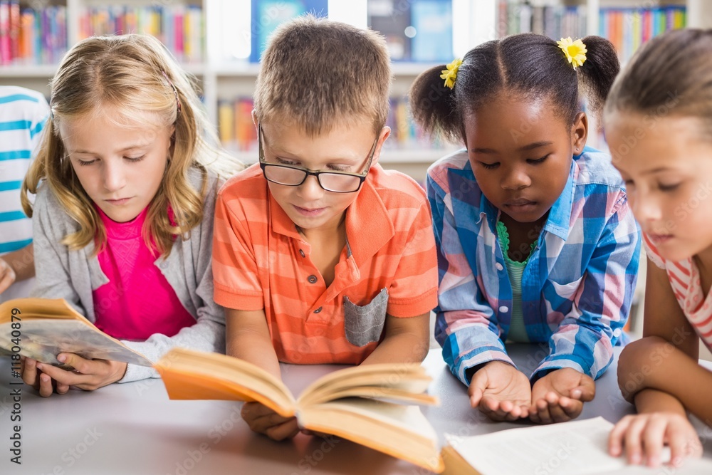 Kids reading a book in library Stock Photo | Adobe Stock