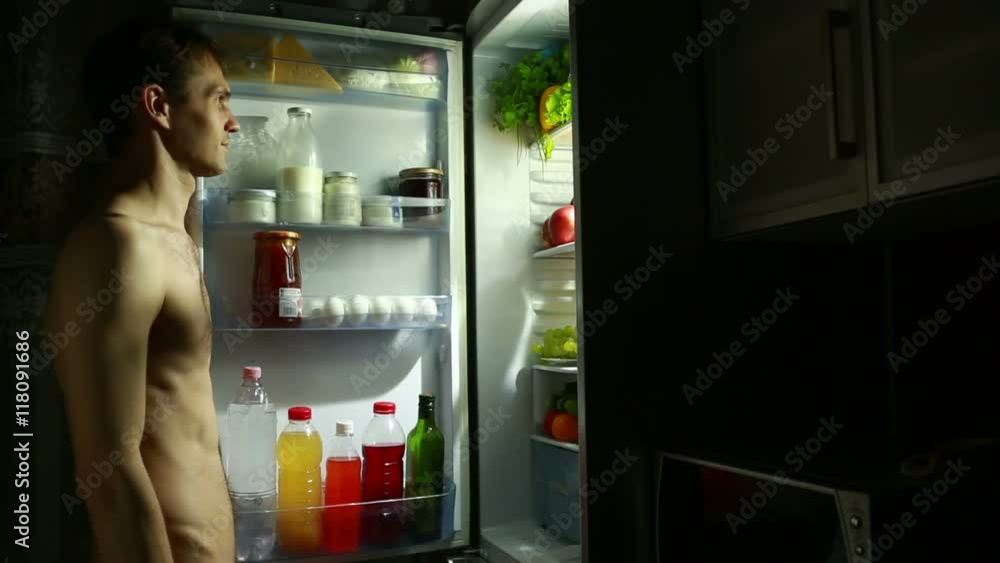 man eating out of the refrigerator at night. eating pepper Stock Video ...