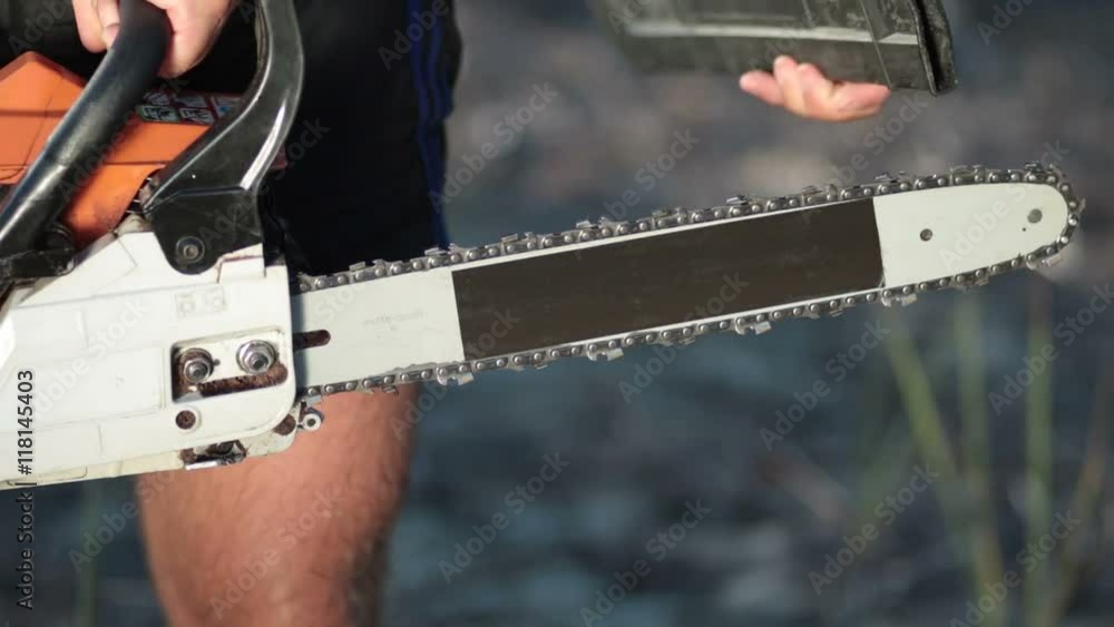 Close up view of man holding chainsaw Stock Video | Adobe Stock