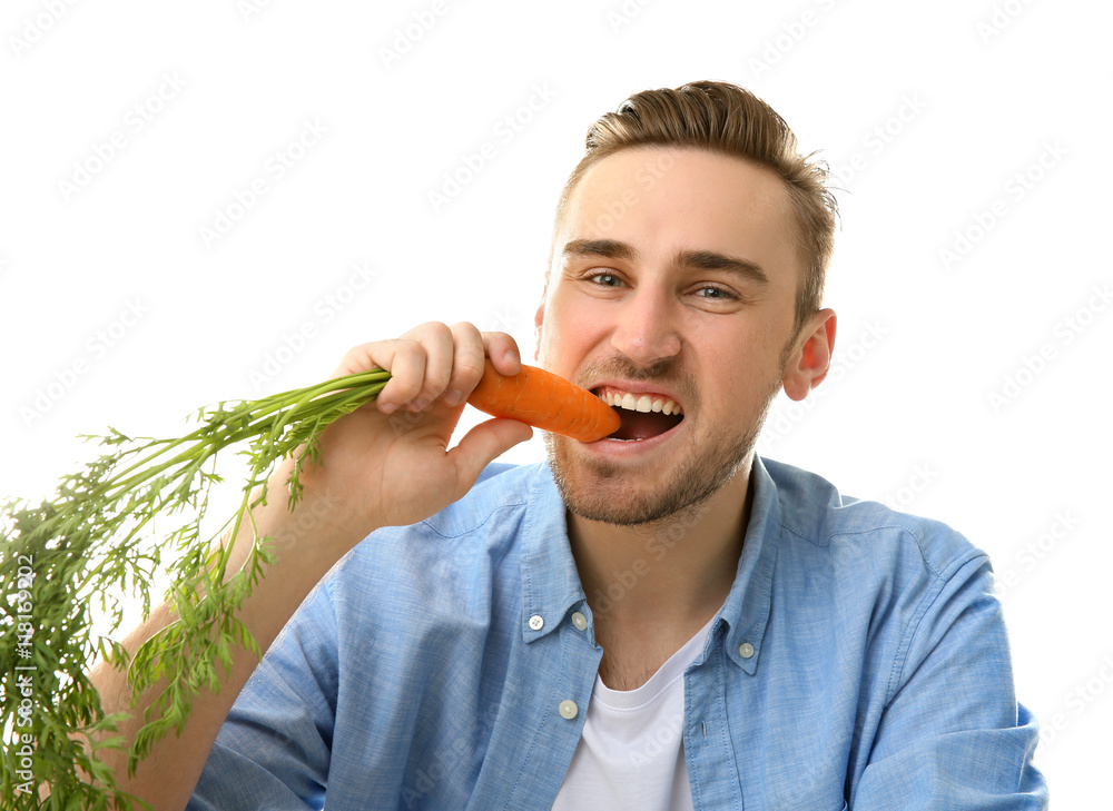 Handsome man eating carrot, isolated on white Stock Photo | Adobe Stock