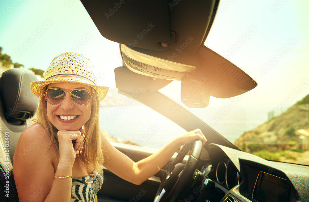 Cute woman driving convertible car Stock-Foto | Adobe Stock
