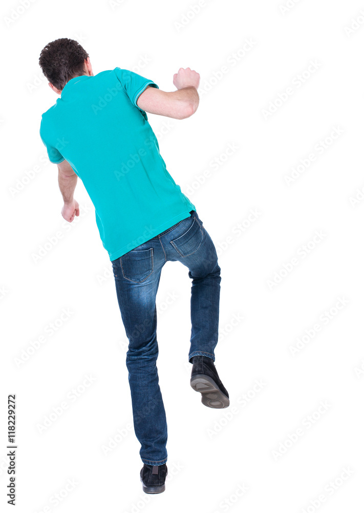 Balancing young man. or dodge the falling man. Rear view people ...
