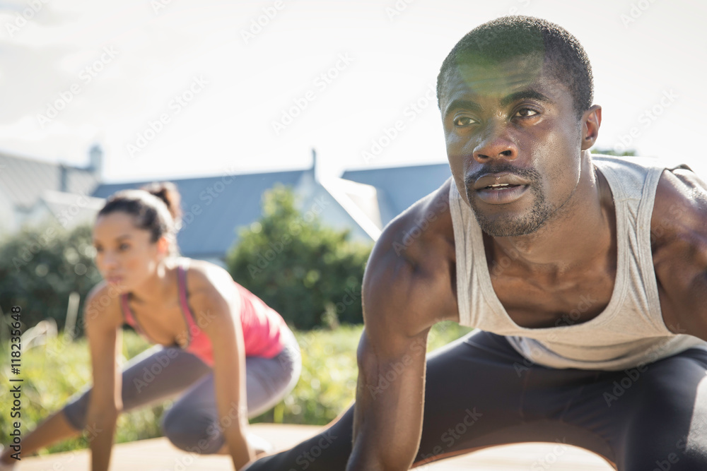 Couple crouching stretching legs Stock Photo | Adobe Stock