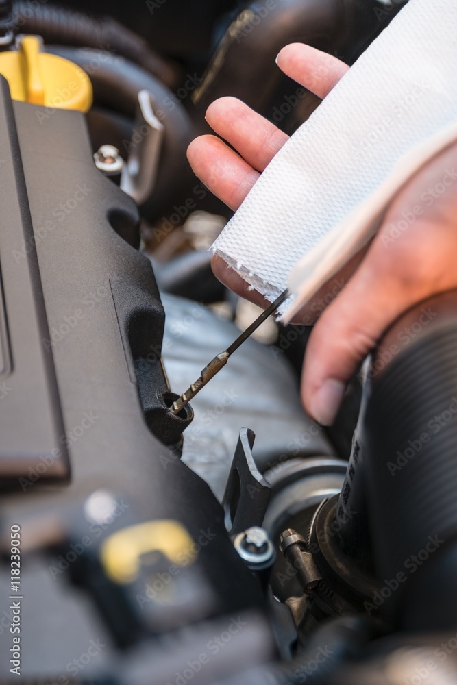 Oil level check in a modern car engine by verifying the dipstick Stock ...