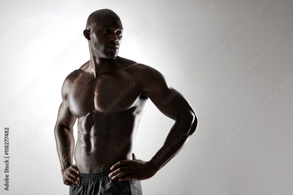 Shirtless male model posing against grey background Stock Photo | Adobe ...