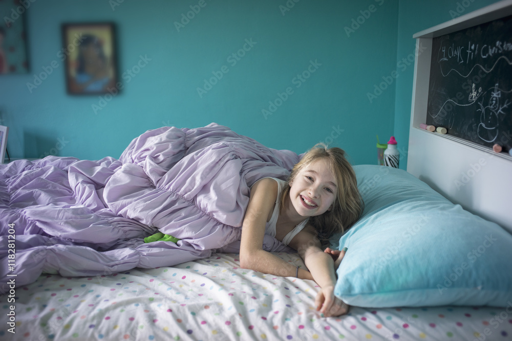 Caucasian girl laying on bed Stock Photo | Adobe Stock