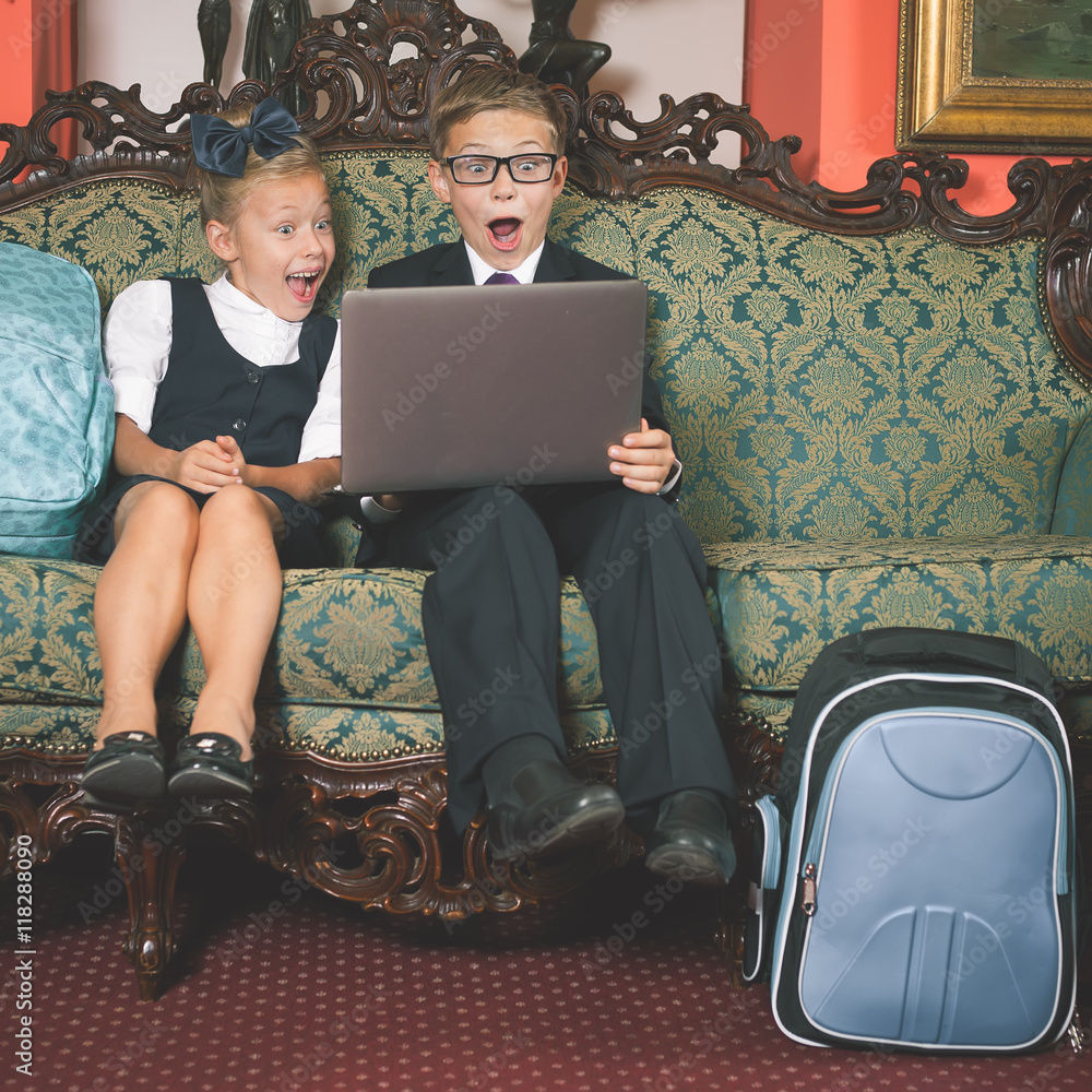 Surprised school kids use laptop computer Stock Photo | Adobe Stock