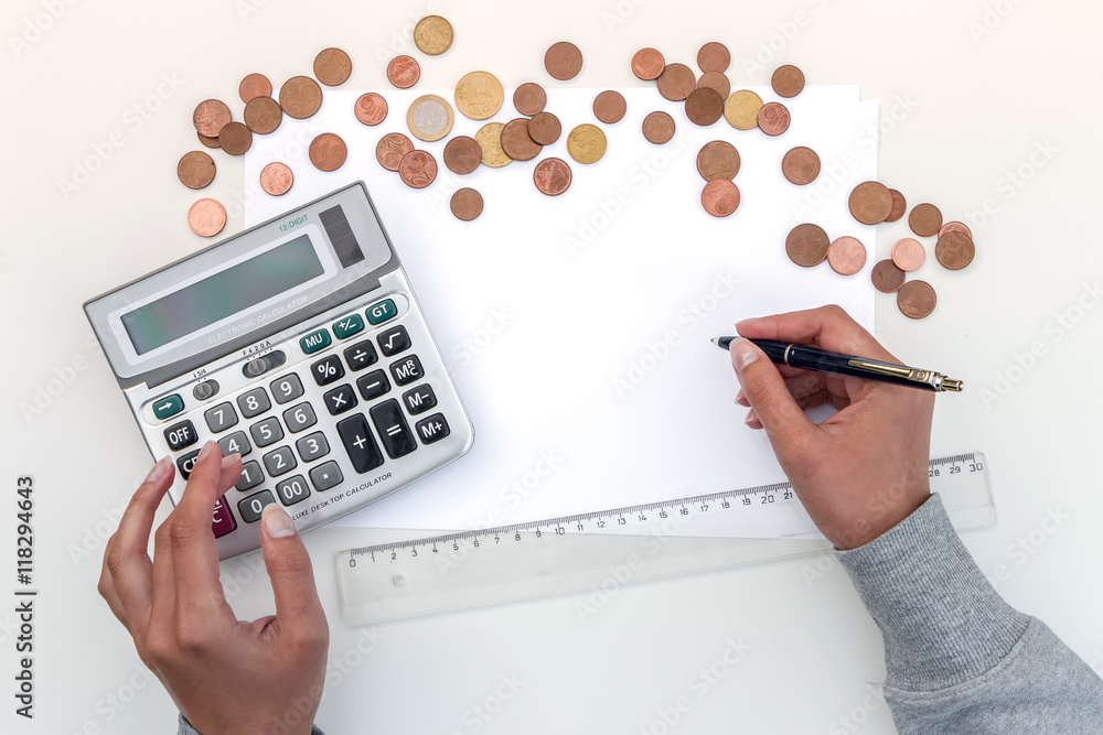 Woman managing her financial situation. Female hands with pen ...