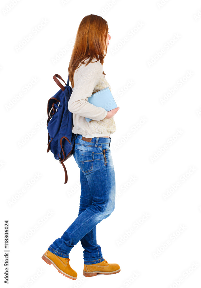 Girl comes with stack of books. side view. Rear view people collection ...