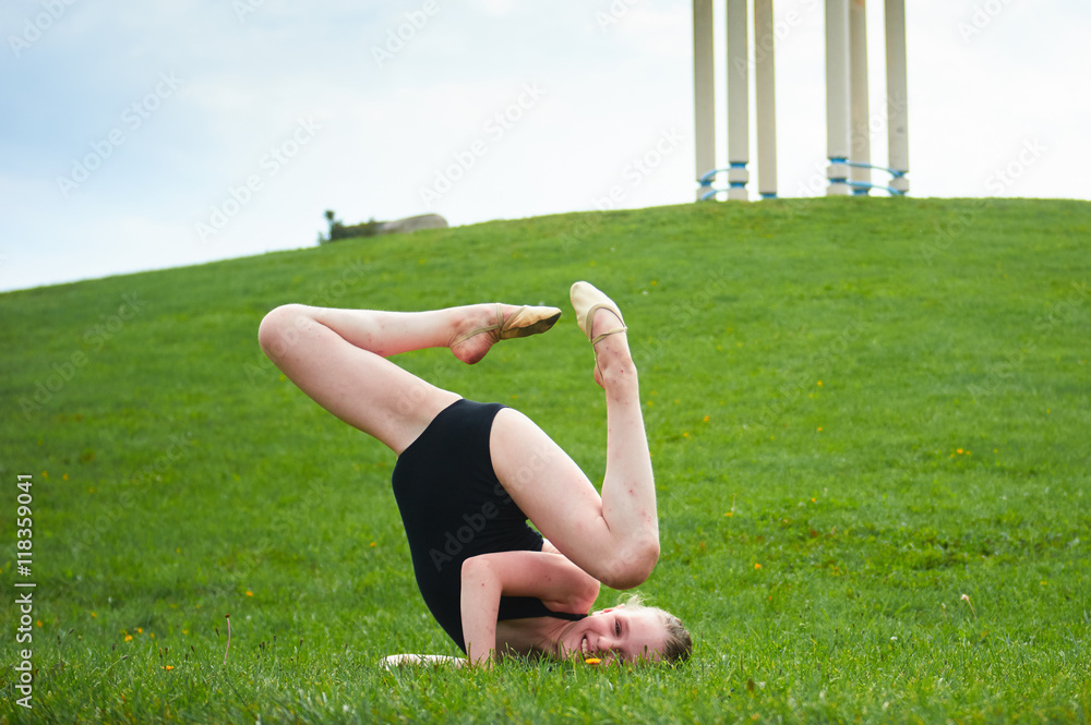 Young beautiful preteen girl doing gymnastics outdoors Stock Photo ...