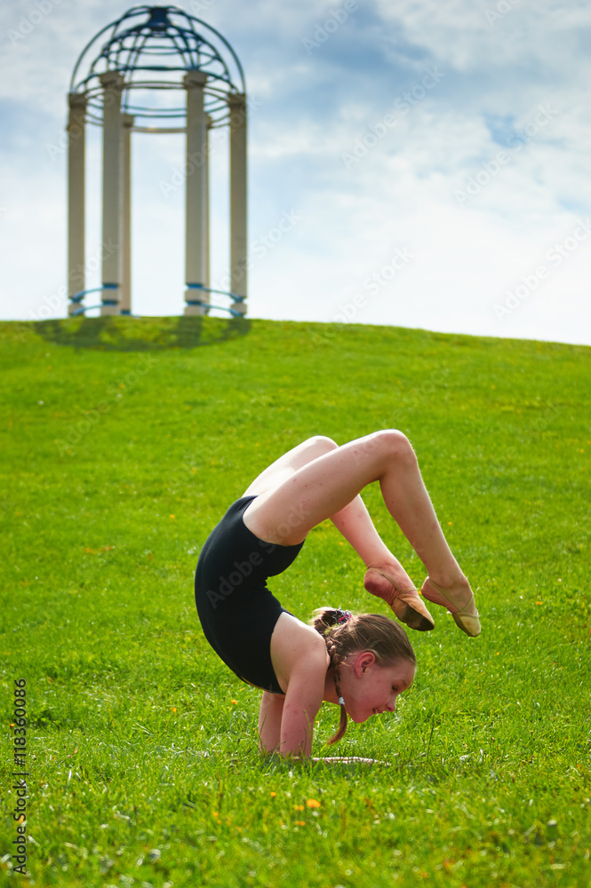 Young beautiful preteen girl doing gymnastics outdoors Stock Photo ...