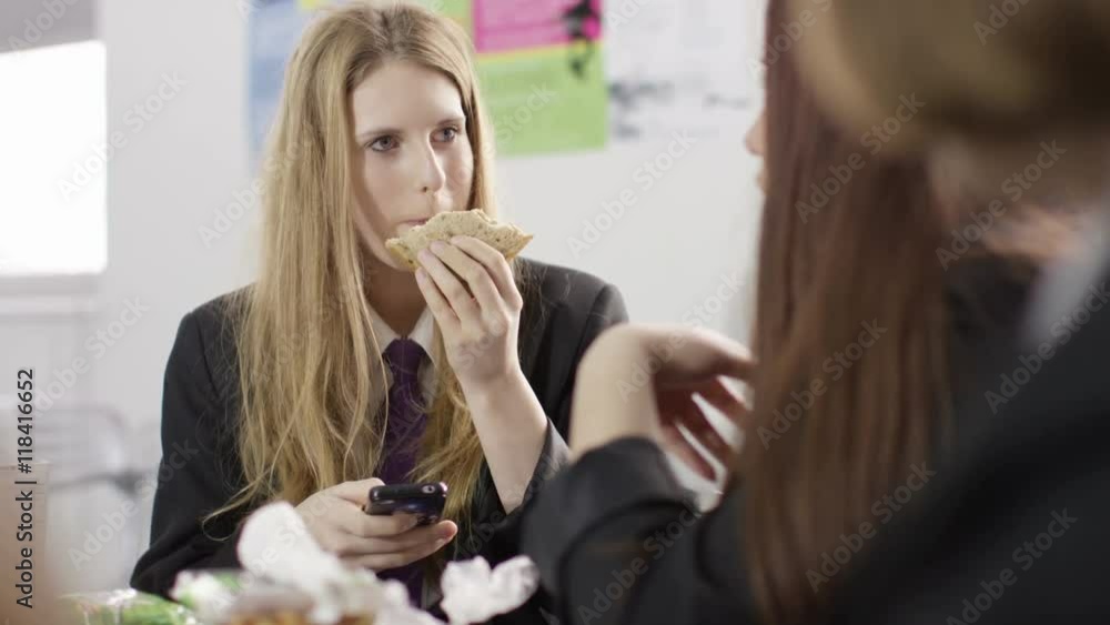 Happy teen girls talking during lunch break in school cafeteria Stock ...