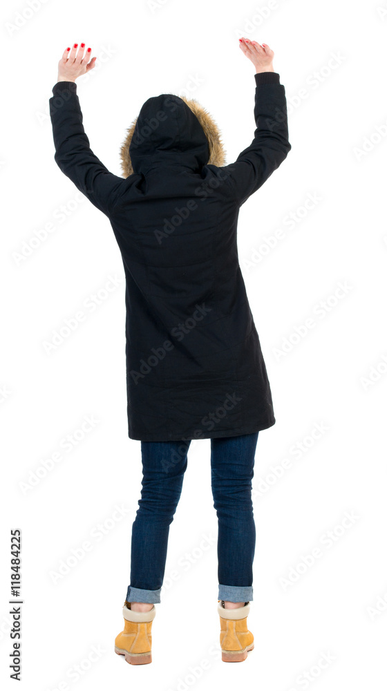 Back view of woman. Raised his fist up in victory sign. Raised his fist up in victory sign. Rear ...