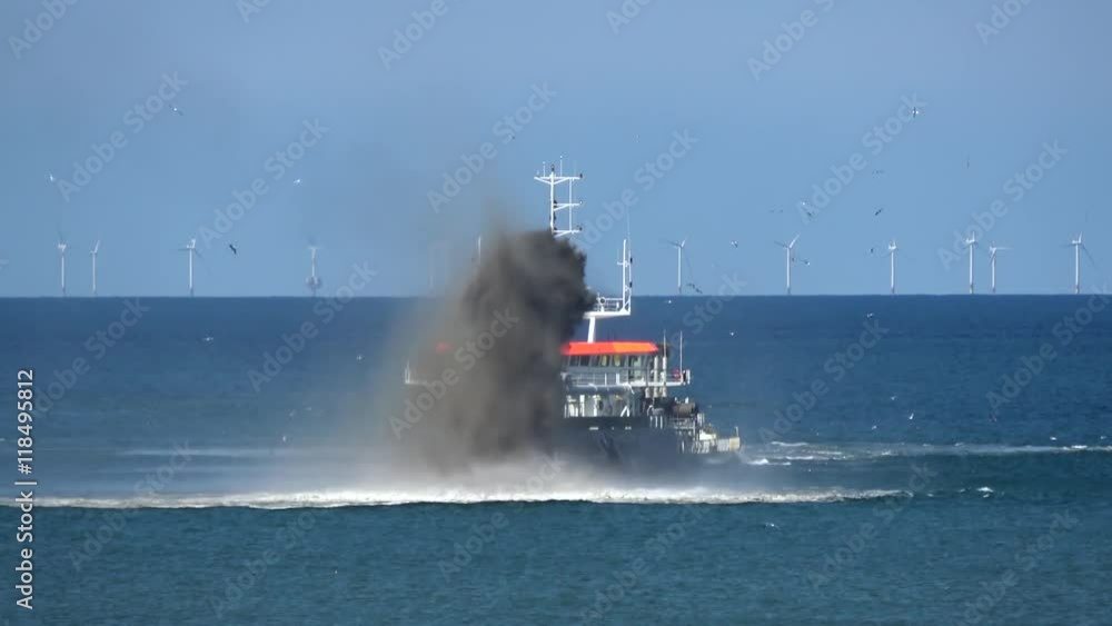 Close up of ship at sea dredging an excavation activity done in shallow ...