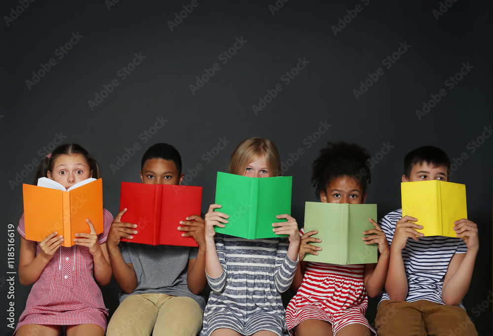 Cute kids reading books on grey background Stock Photo | Adobe Stock