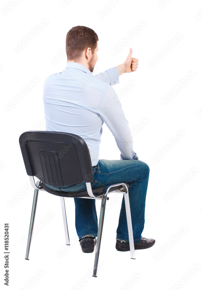 back view of young business man sitting on chair and thumbs up. man ...