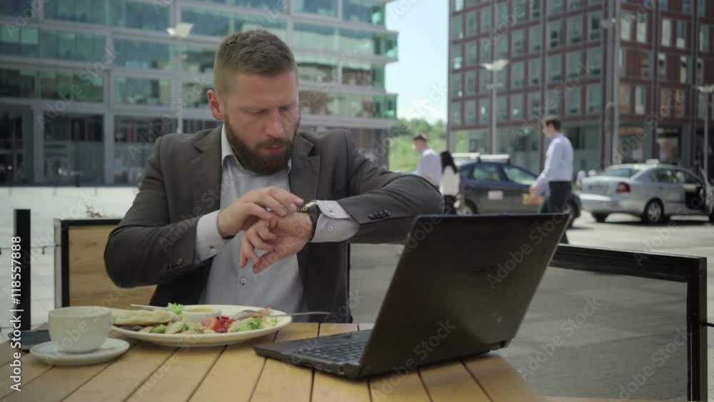 Businessman eating lunch is in hurry, drinks coffee and goes away. He ...