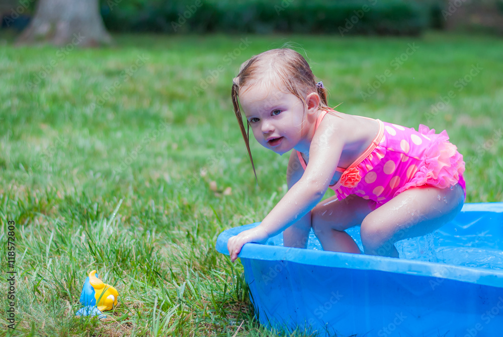 Little Girl Playing in a Kiddie Pool Stock Photo | Adobe Stock