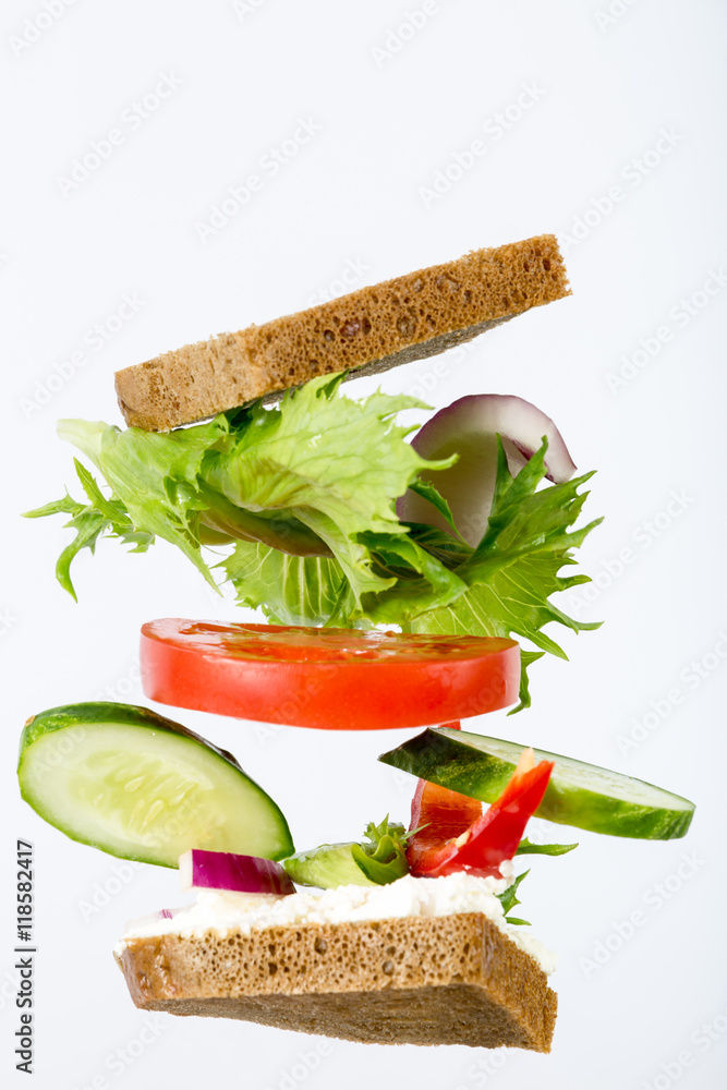 Delicious sandwich ingredients fall between the bread Stock Photo ...