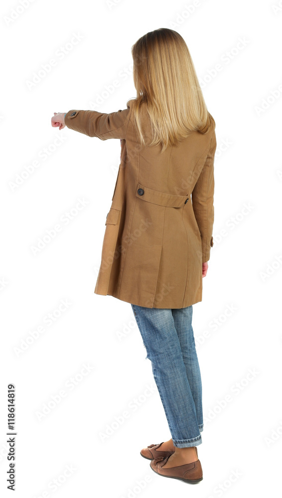 Back view of pointing young women in parka. Young girl gesture. Rear ...