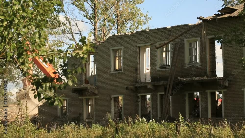 Demolition old house. excavator destroys old brick two-storey building ...